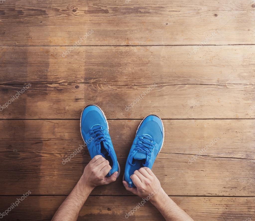 Man holding Running shoes Stock Photo by ©halfpoint 71965195