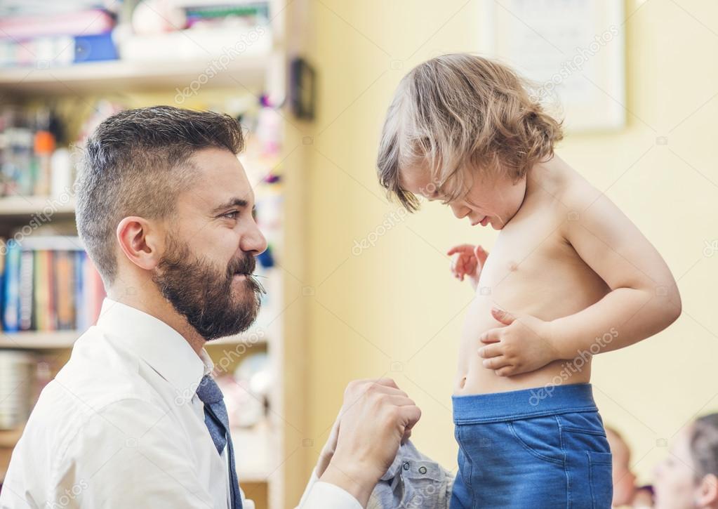 Father getting his daughter ready in a morning Stock Photo by ...