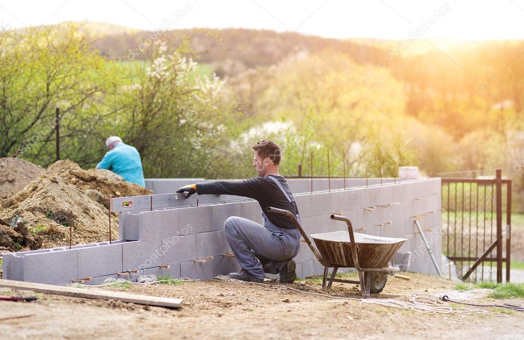 Man building a house Stock Photo by ©halfpoint 74779683