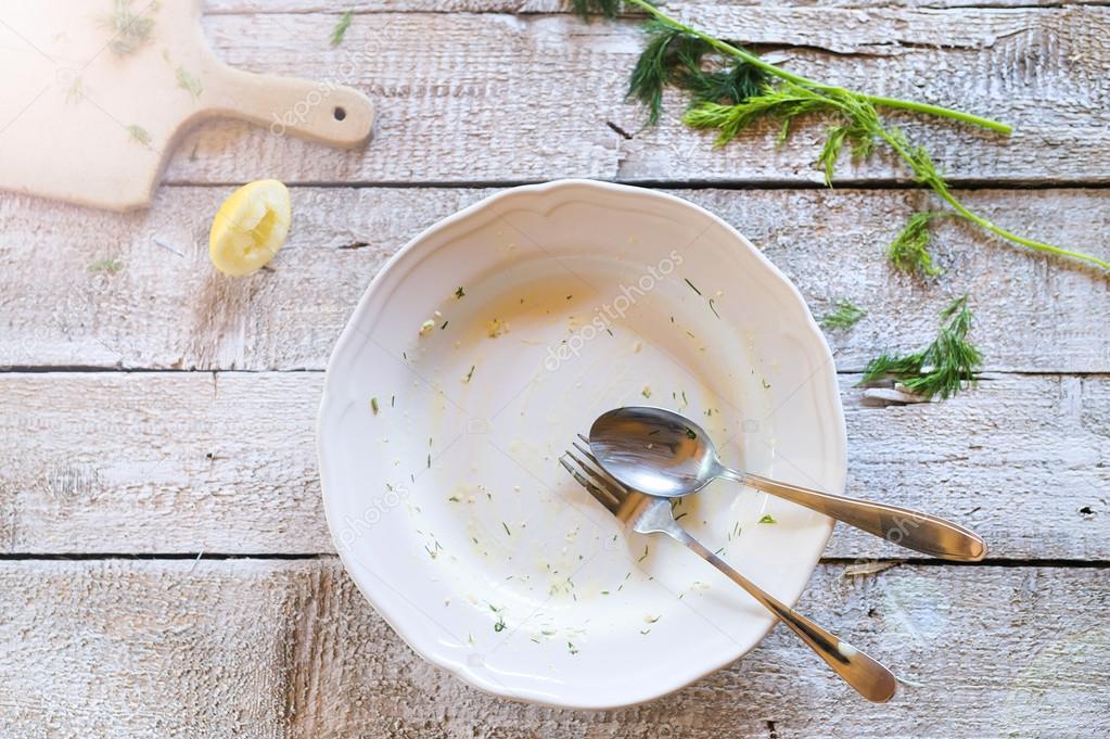 Empty plate on wooden table Stock Photo by ©halfpoint 84717364