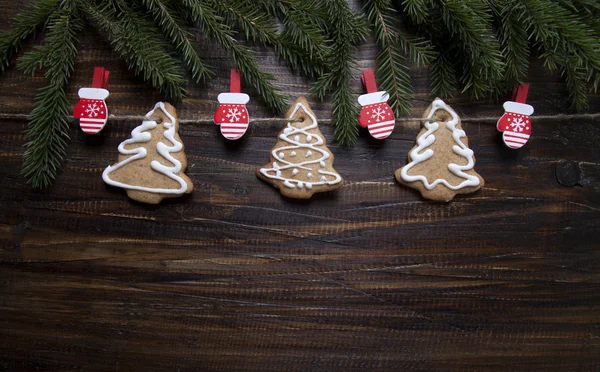 Christmas background with cookies decorated with icing, with clo ...