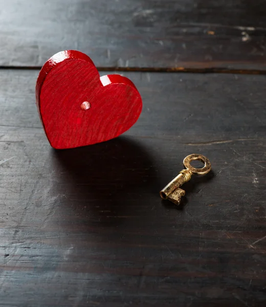 'Key to My Heart' love concept, with gold heart shape key and red heart ...
