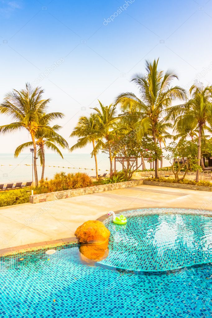 Luxury Swimming pool with palm trees Stock Photo by ©mrsiraphol 102211028