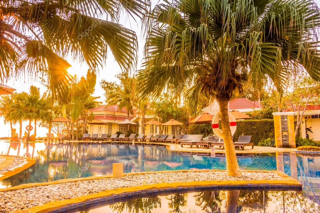 Swimming pool resort at Sunset times Stock Photo by ©mrsiraphol 105088172