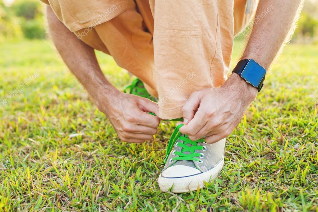 Man tying his shoe strings — Stock Photo © apid #89609446