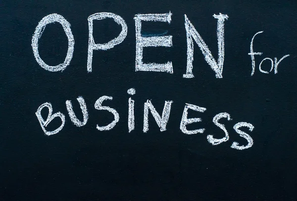 Open for business sign message handwritten with white chalk on ...
