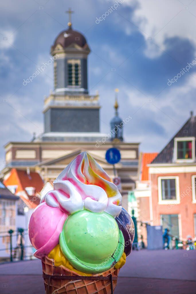 A model of ice cream in a cone with church towers in the background 2022