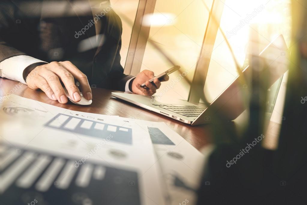 Business documents on office table with smart phone and laptop c Stock ...