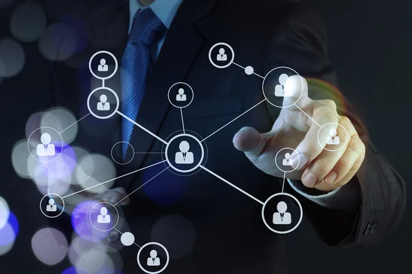 Businessman hand showing human icon flow chart on new modern com ...