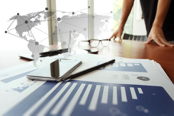 business documents on office table with digital tablet and man w ...