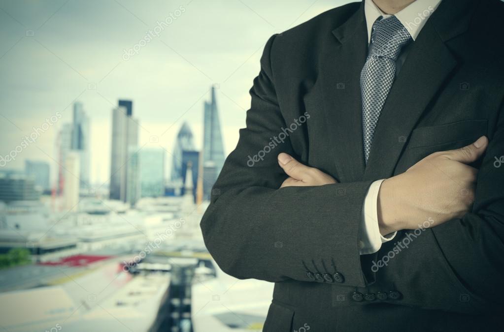 Businessman stands successfully on building top thinking Towards Stock ...