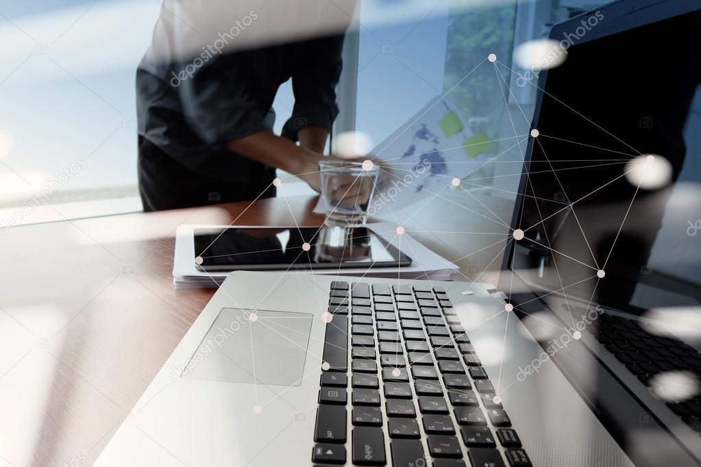 Double exposure of businessman hand working with new modern comp ...