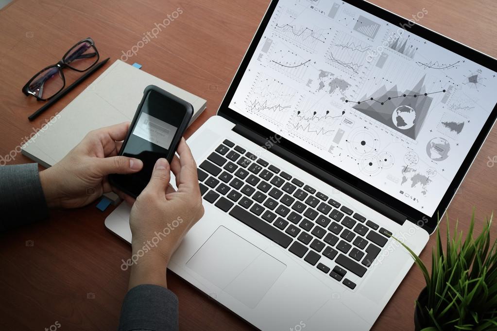 Top view of hands using laptop and holding smart phone with digi Stock ...