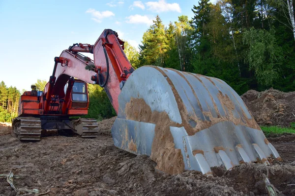Excavator during groundwork at forest area for construction new road ...