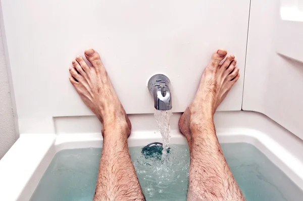Man Resting In Tub With Feet Up and Water Running - Stock Image ...