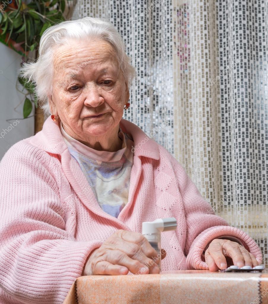 Old woman with asthma inhaler Stock Photo by ©VBaleha 62153931