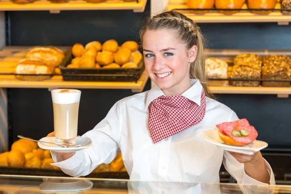 Shopkeeper at bakery working at cash register — Stock Photo ...