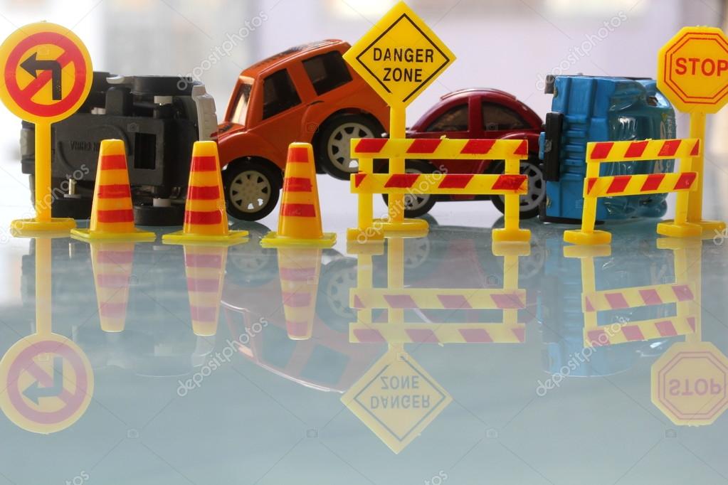 Car Accident zone cordoned off with a yellow stop sign post. two cars ...