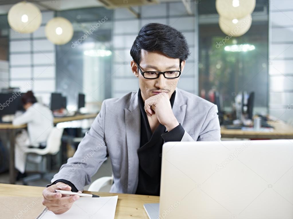 Young asian businessman working in office — Stock Photo © imtmphoto ... Young asian businessman working in office — Stock Photo © imtmphoto ...