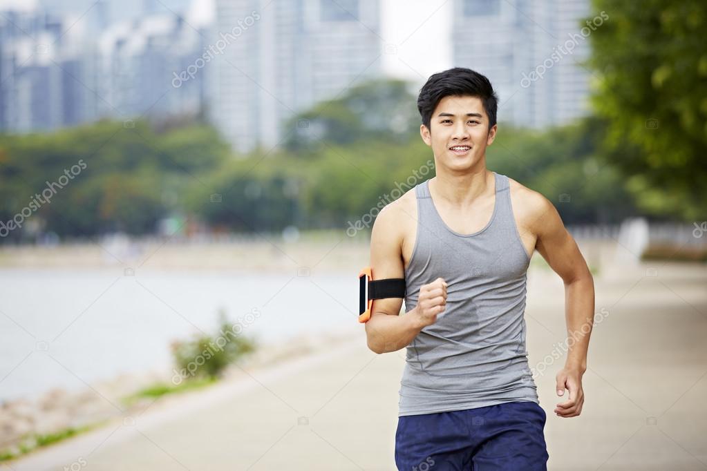 Young asian jogger running in park Stock Photo by ©imtmphoto 122343574