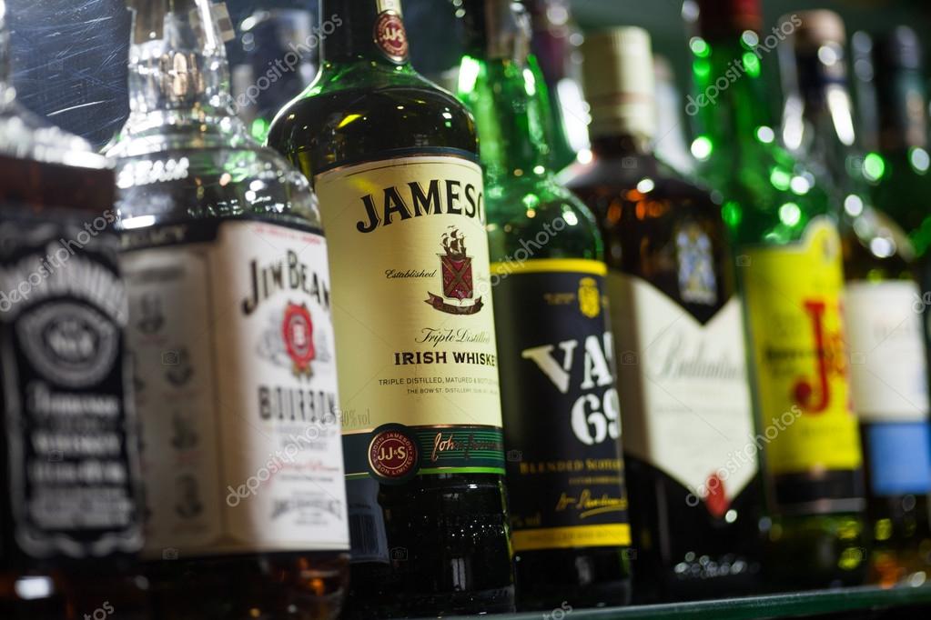 Alcohol bottles in a bar – Stock Editorial Photo © bizoon #104391888