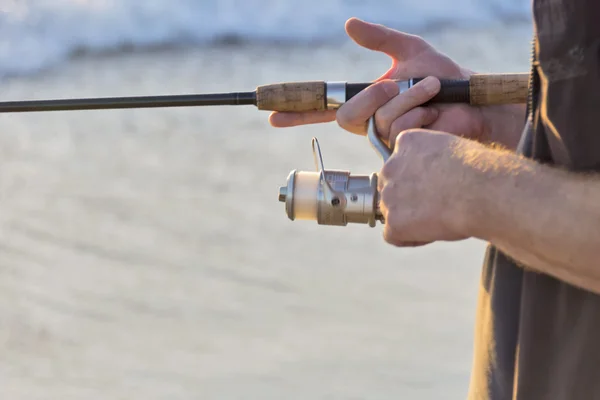 The hands of an angler with fishing rod - Stock Image - Everypixel