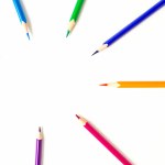 Colored pencils lie in a circle on an isolated white background. Copy ...