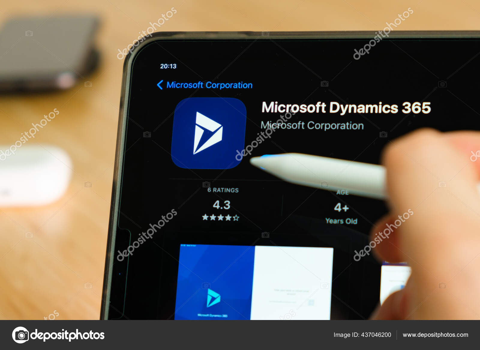 Microsoft dynamics 365 logo shown by apple pencil on the iPad Pro tablet screen. Man using ...