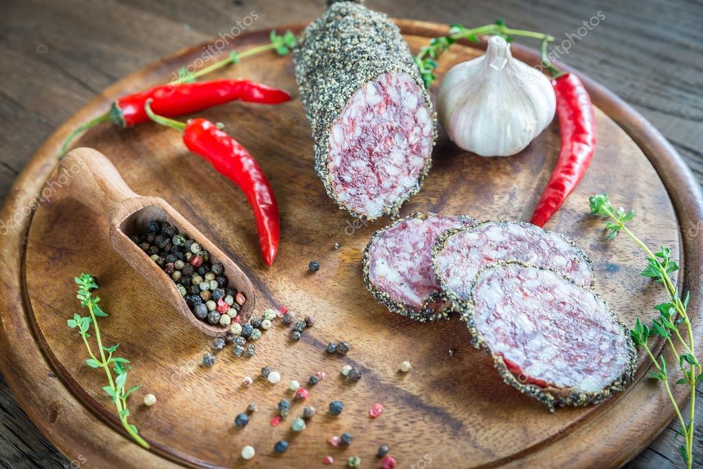 Slices of saucisson on the wooden board Stock Photo by ©alex9500 72706321