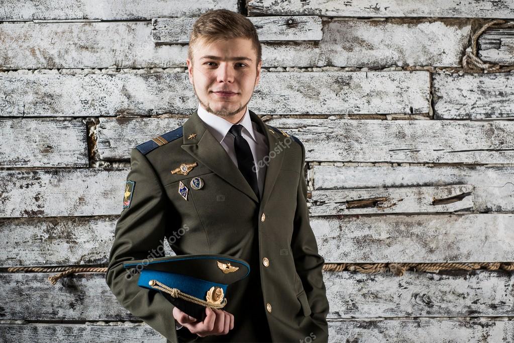 Young Russian Air Force sergeant posing holding his cap in his hands ...