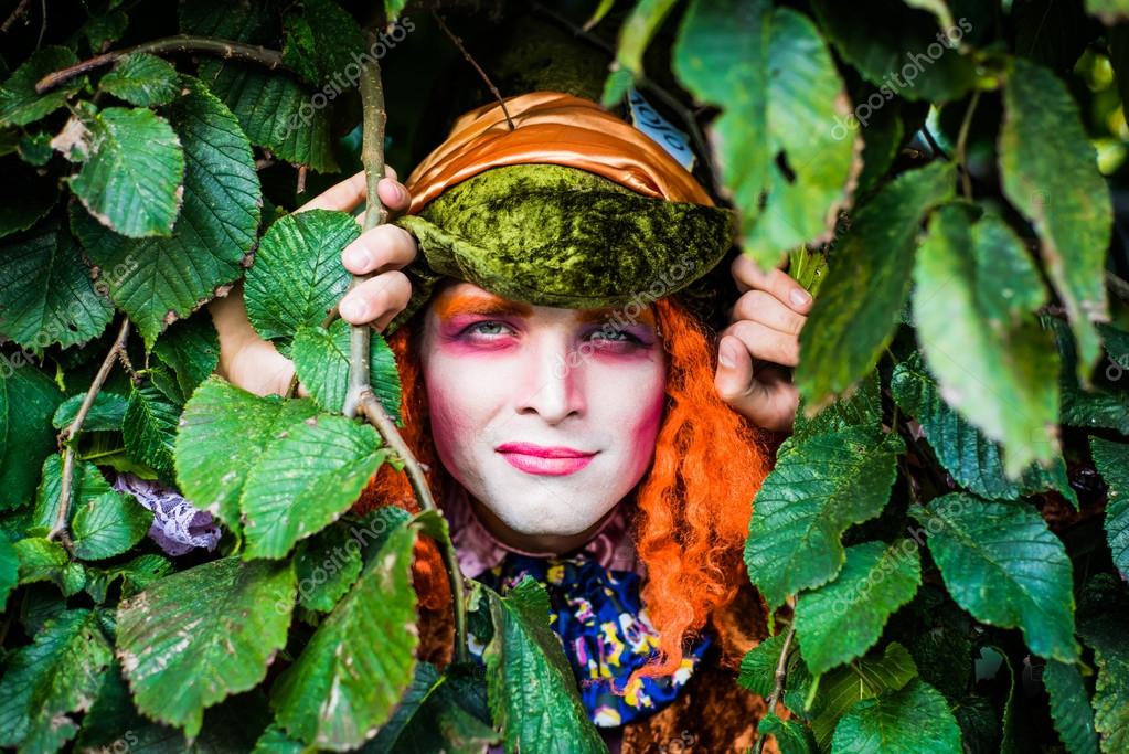 Young man in the image of the Hatter from the fairy tale about Alice ...
