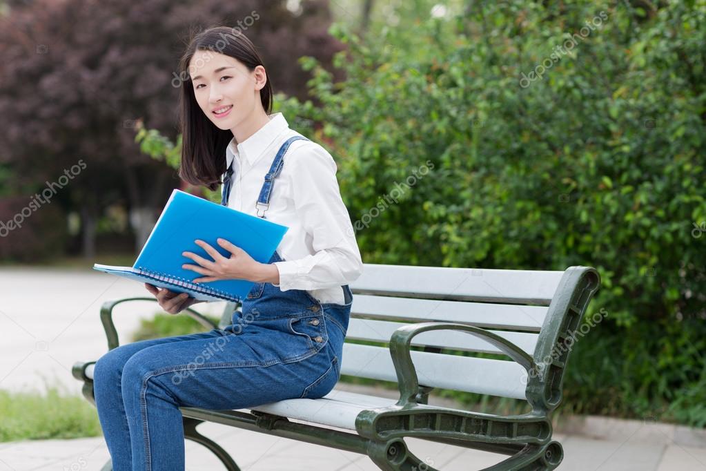 Person Sitting On Bench Reading