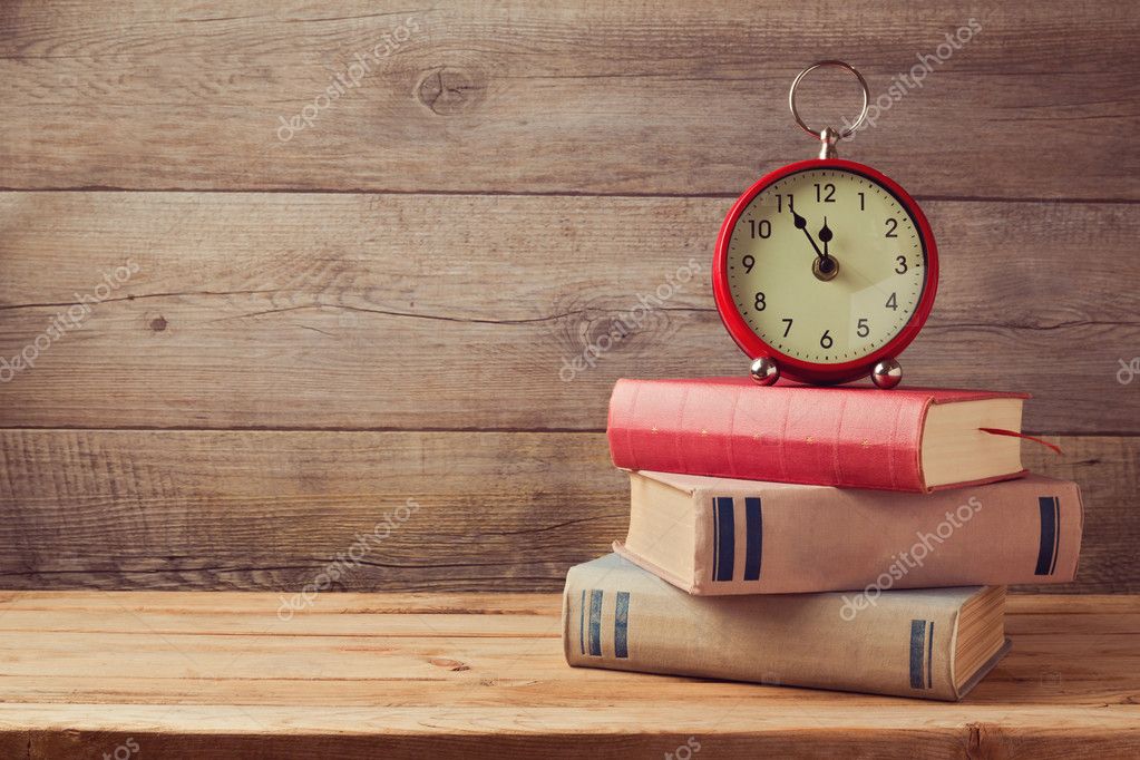 Books and clock on wooden table Stock Photo by ©maglara 58435797