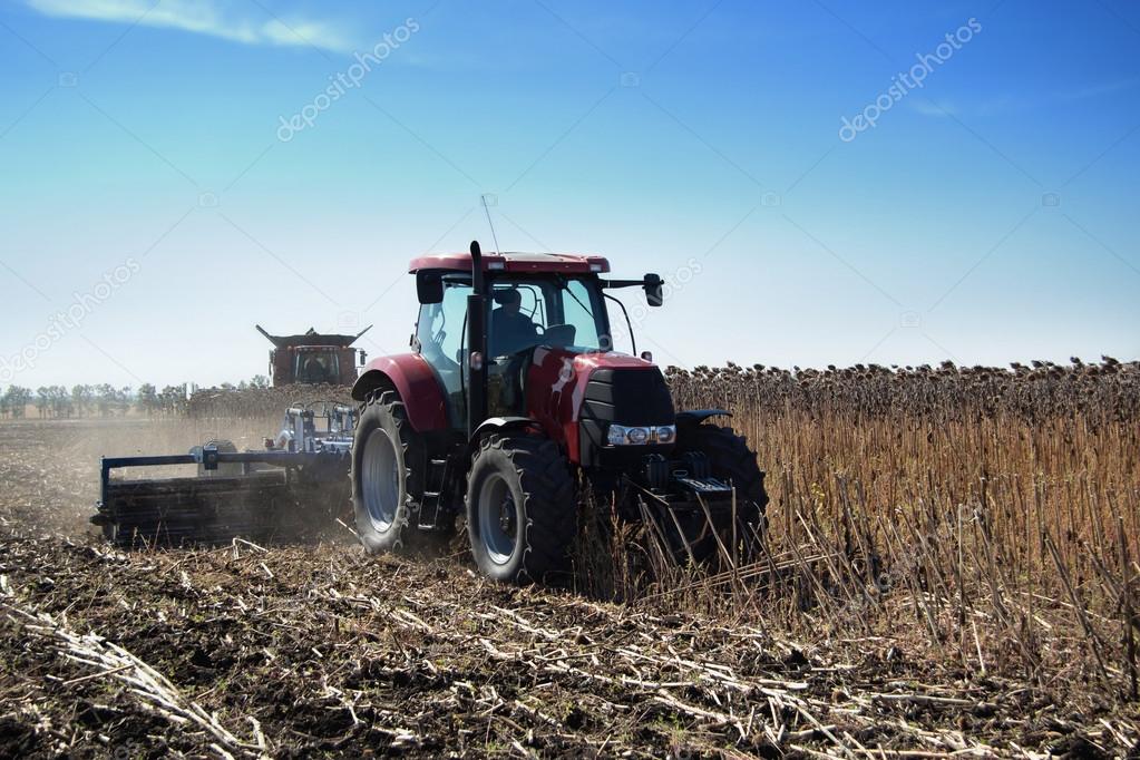 The tractor works in a field — Stock Photo © Veremeev #87660512