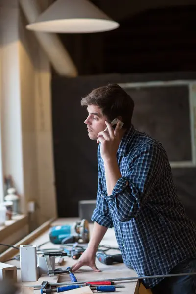 Carpenter working on his craft in a dusty workshop - Stock Image ...