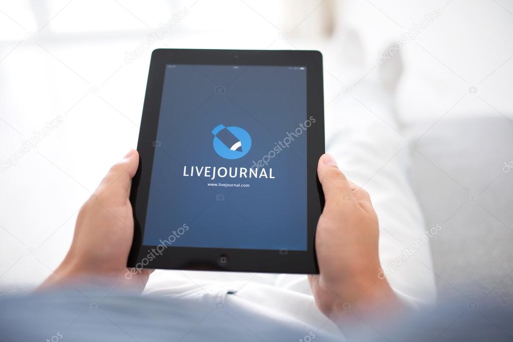Man lying on a sofa and holding iPad with app LiveJournal on the – Stock Editorial Photo ...