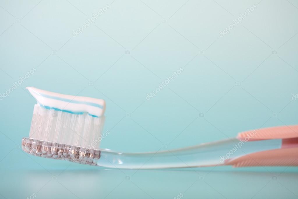 Refreshing stripy toothpaste on a new toothbrush — Stock Photo © mjth ...
