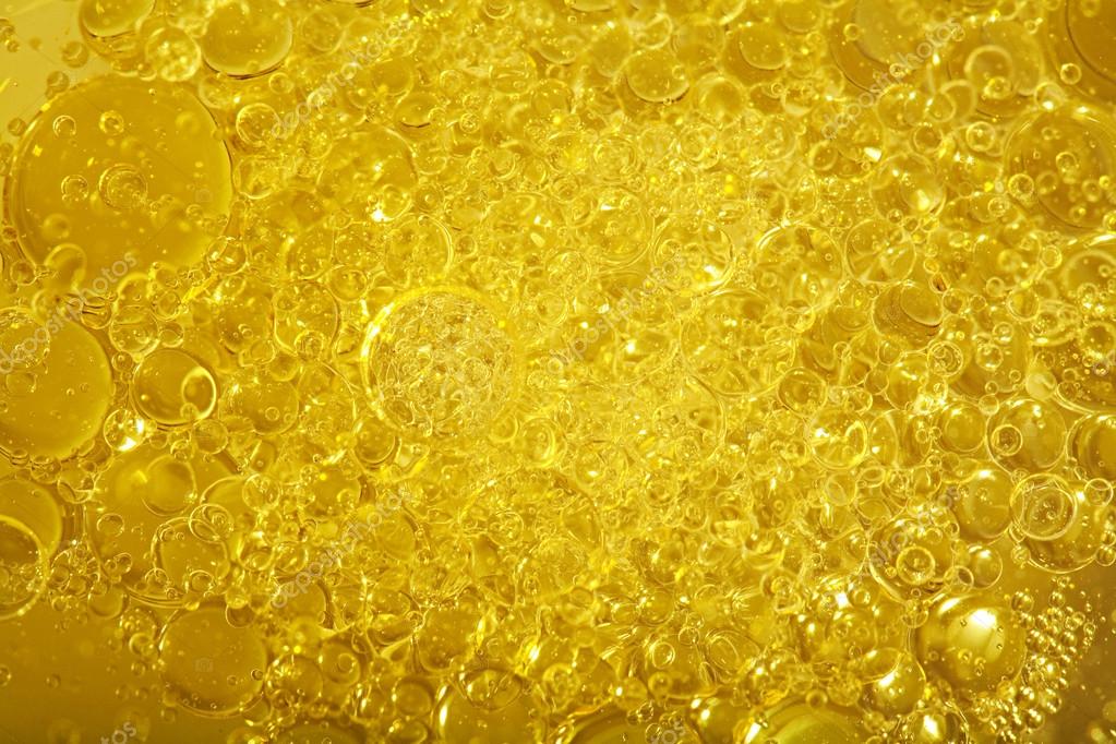 Background detail view of golden shining yellow oil boiling — Stock ...