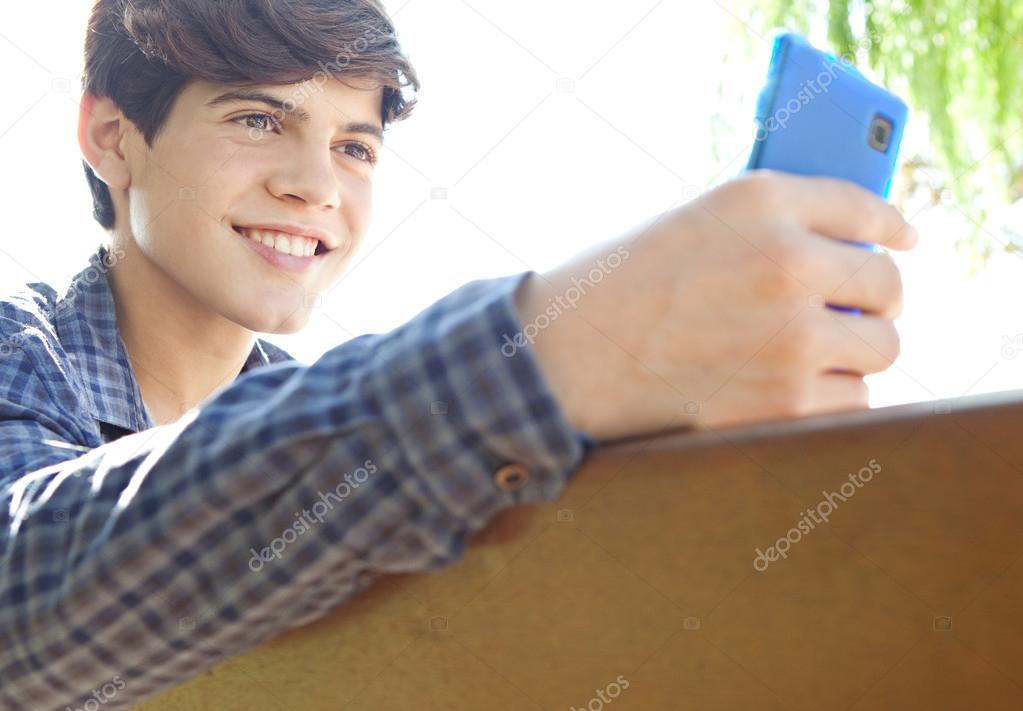 Boy using his smartphone device — Stock Photo © mjth #79460010