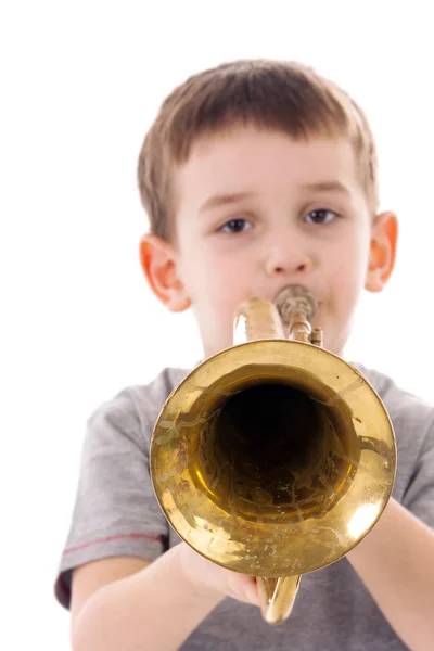 Young boy blowing into a trumpet against white background Stock Photo ...