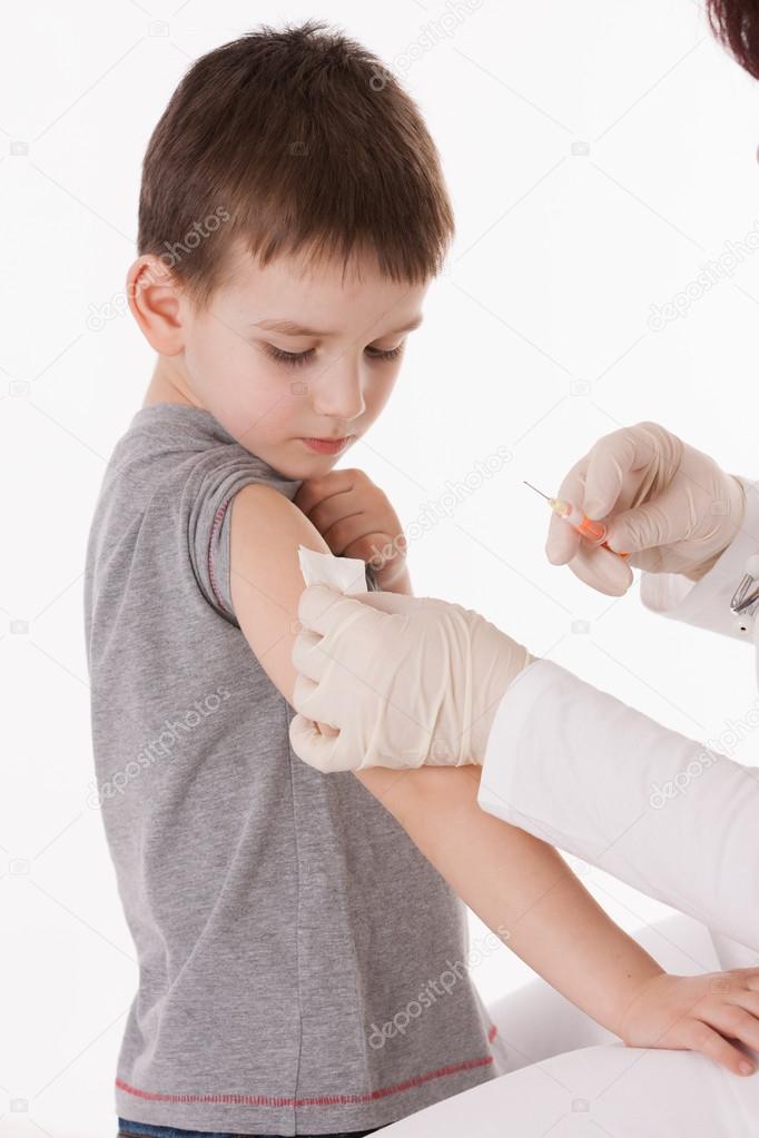 Doctor giving a child injection in arm on isolated image. — Stock Photo ...