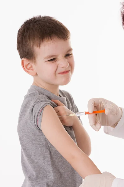 Doctor giving a child injection in arm on isolated image. Stock Photo ...