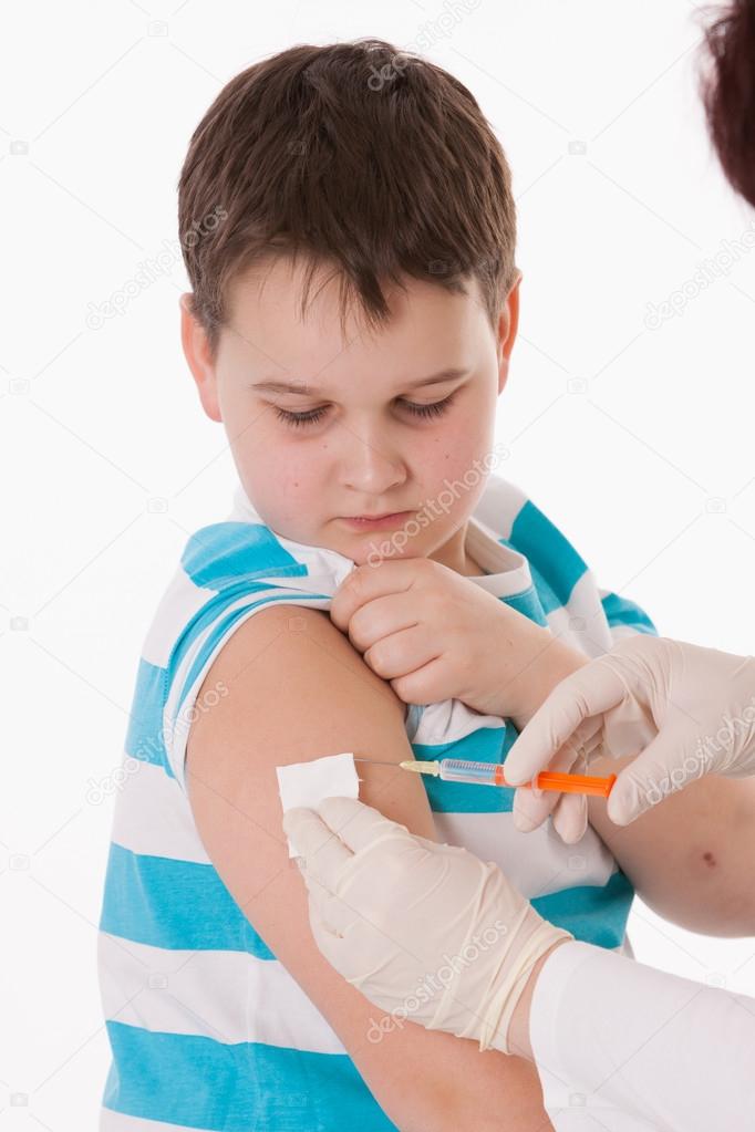 Doctor giving a child injection in arm on isolated image. Stock Photo ...