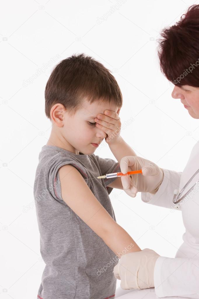 Doctor giving a child injection in arm on isolated image. — Stock Photo ...