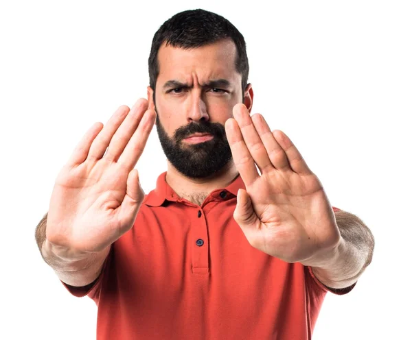 Handsome man making stop sign Stock Photo by ©luismolinero 105156076