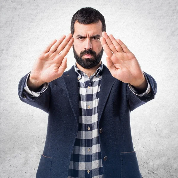 Handsome man making stop sign Stock Photo by ©luismolinero 105156076