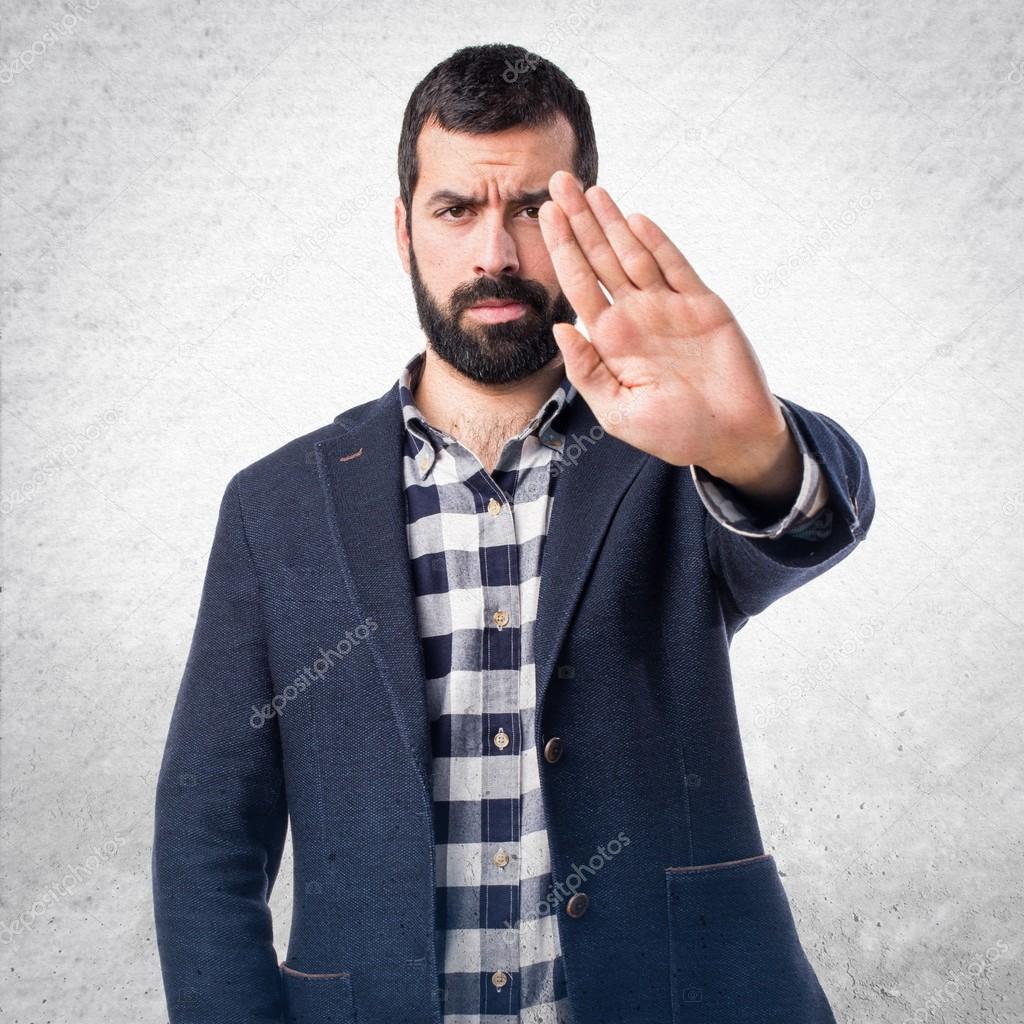 Handsome man making stop sign Stock Photo by ©luismolinero 105156076