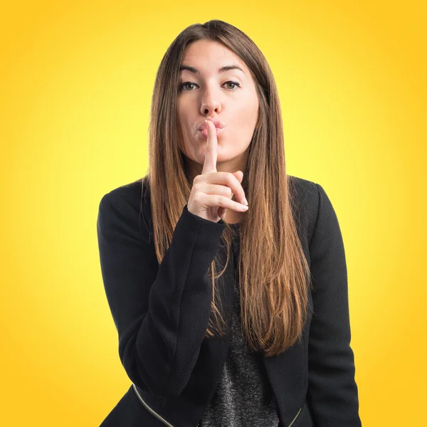 Young girl making silence gesture over isolated ocher background Stock ...