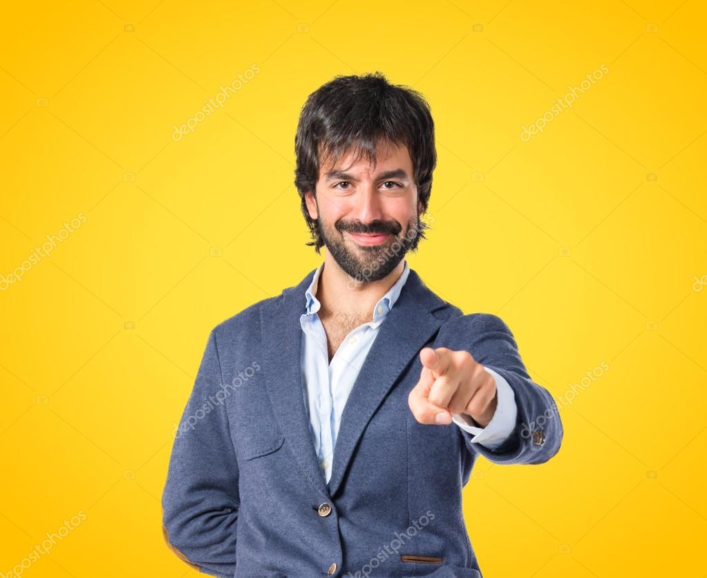 Man pointing to the front over yellow background — Stock Photo ...
