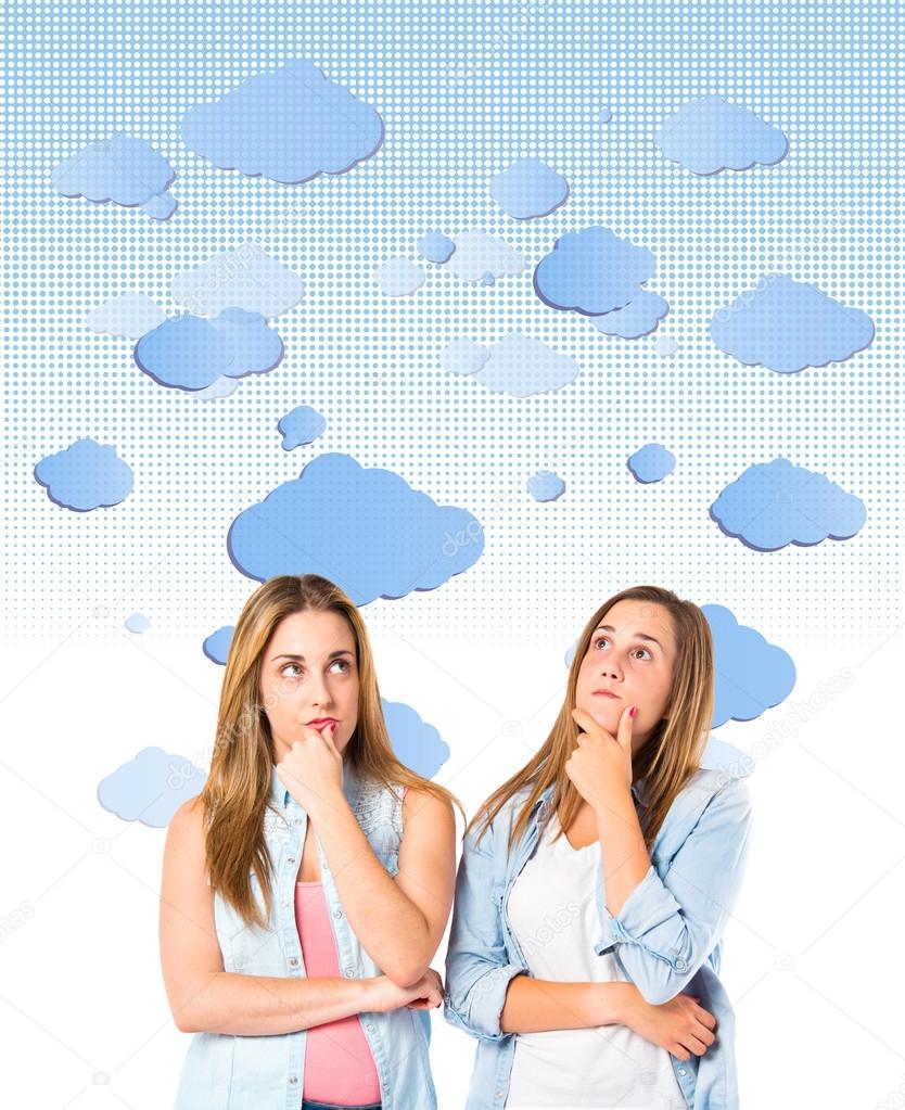 Girls thinking over clouds background Stock Photo by ©luismolinero 58484795